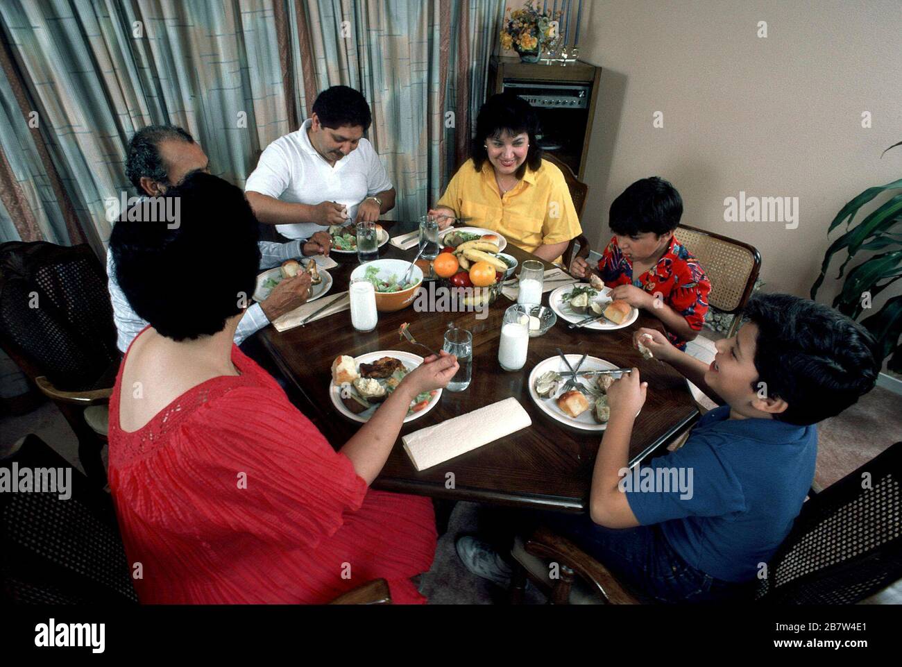 Austin Texas USA, 1987: Multi-generational Hispanic family eating ...