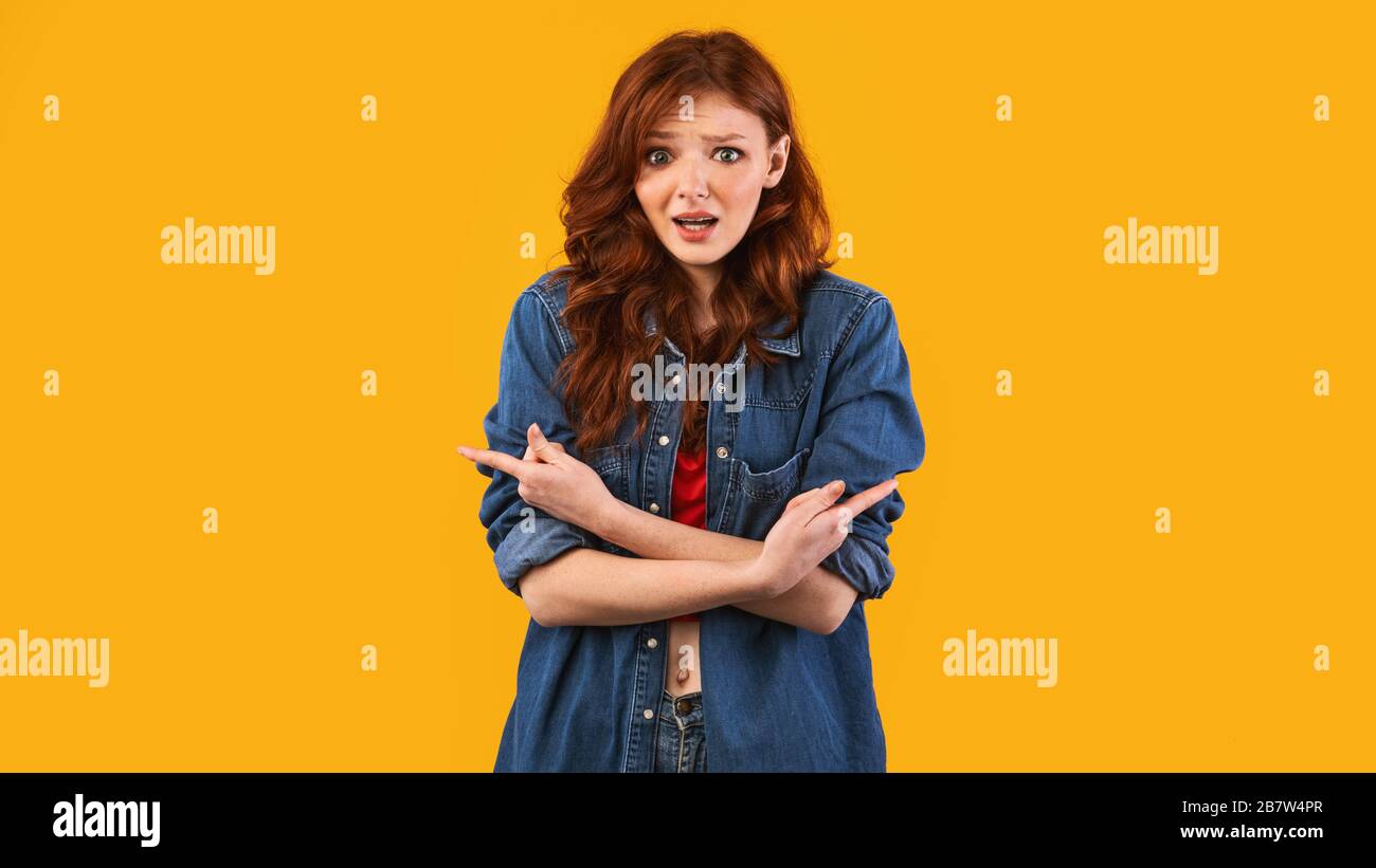 Confused Teen Girl Pointing Fingers In Opposite Directions, Yellow ...