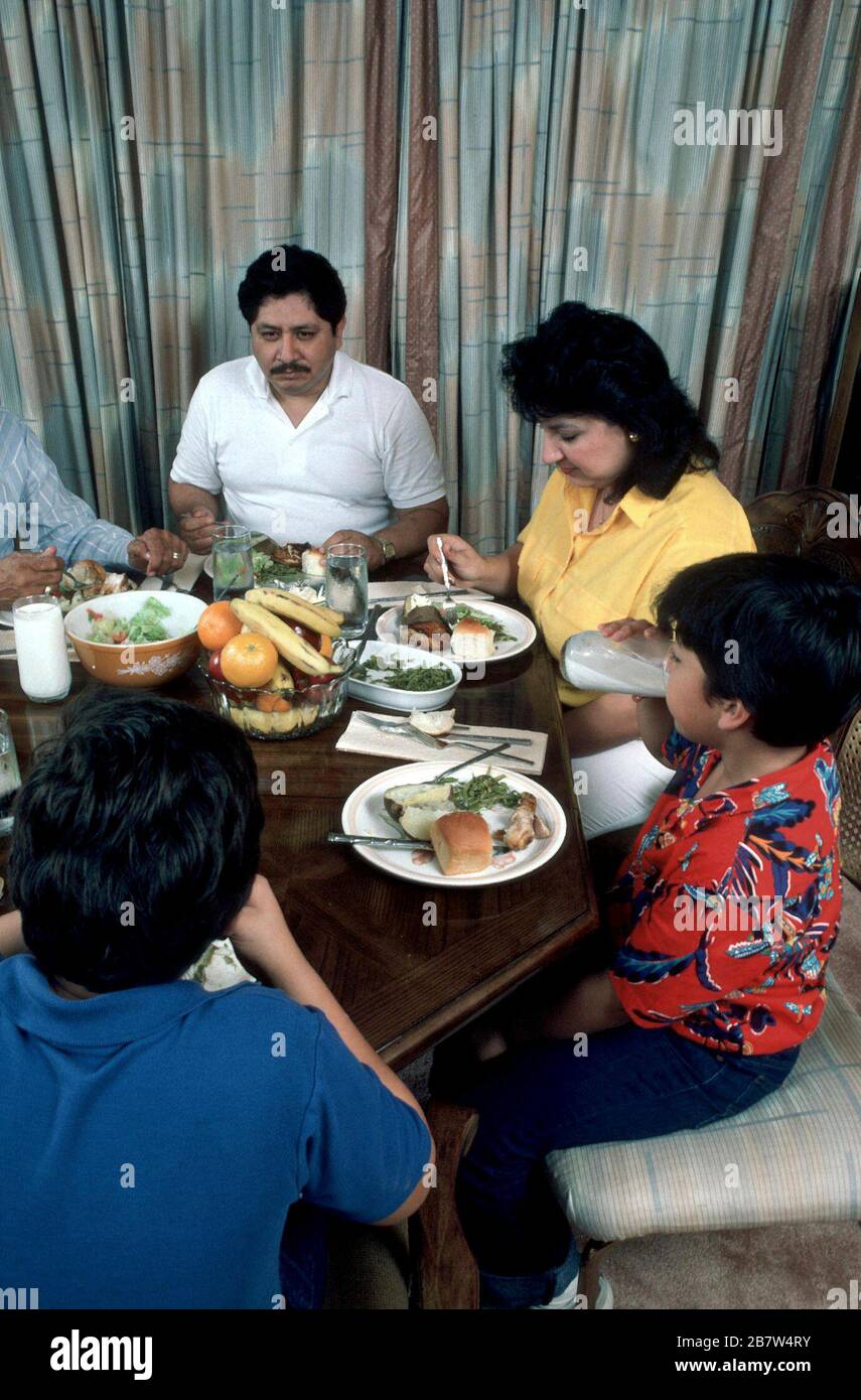 Hispanic family eating nutritious dinner at home. ©Bob Daemmrich Stock ...