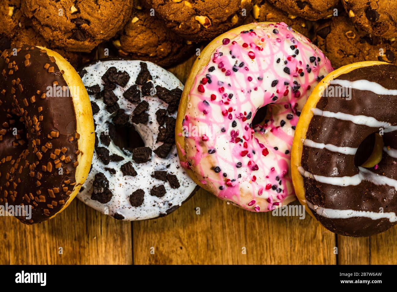 Chocolate chip cookies, biscuits and colorful donuts. Top view and ...
