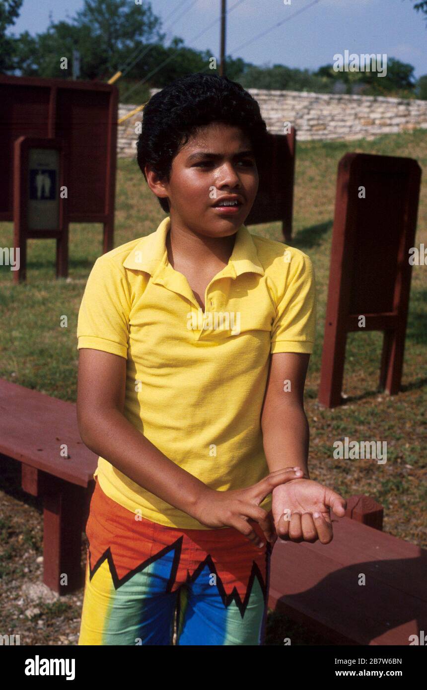 Hispanic fifth grade boy checking his pulse at exercise station. MR ...