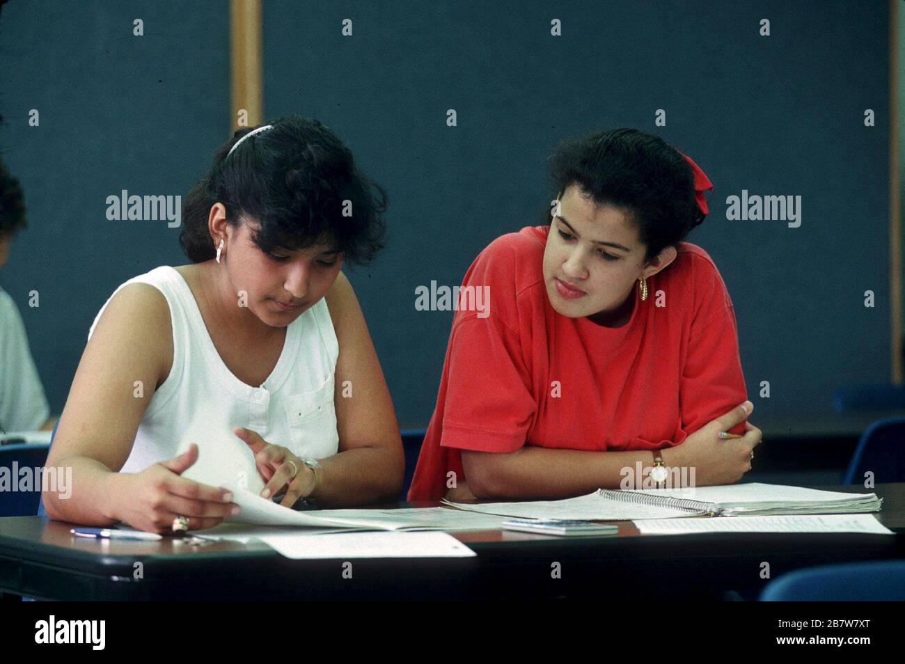 Austin, Texas USA: Hispanic tutor, left, giving accounting lesson to ...
