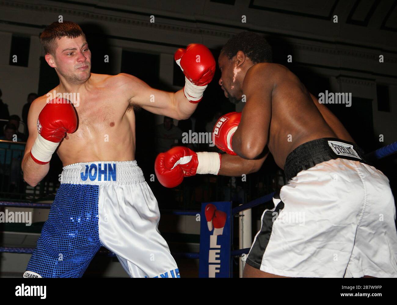 John Wayne Hibbert (white/blue shorts) defeats Bheki Moyo in a boxing ...