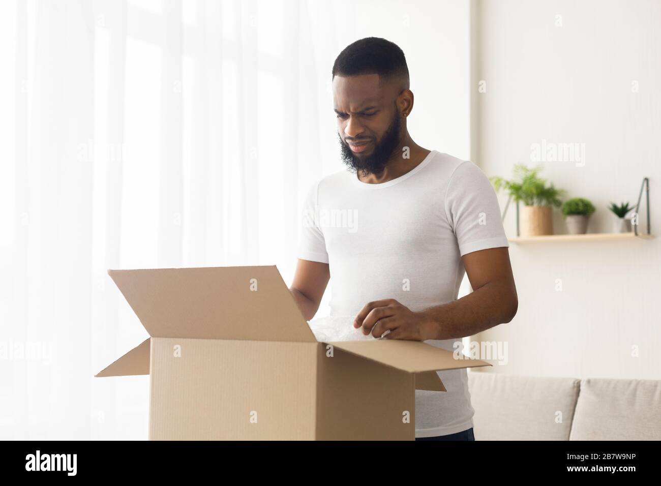 Sad african american millennial guy received wrong order Stock Photo ...