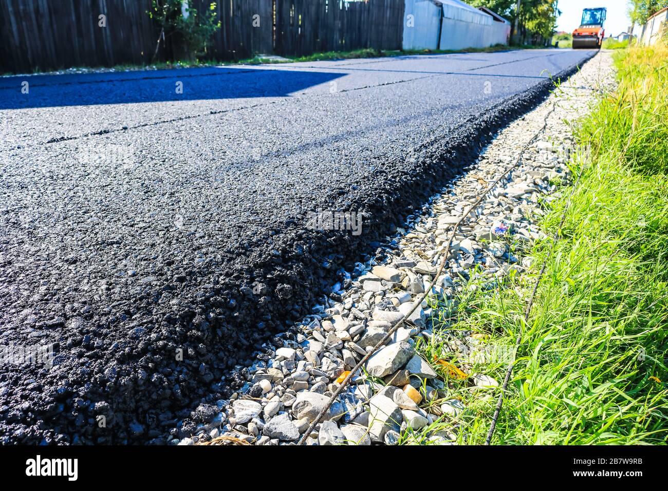 New layer of asphalt road under construction with support from the ...