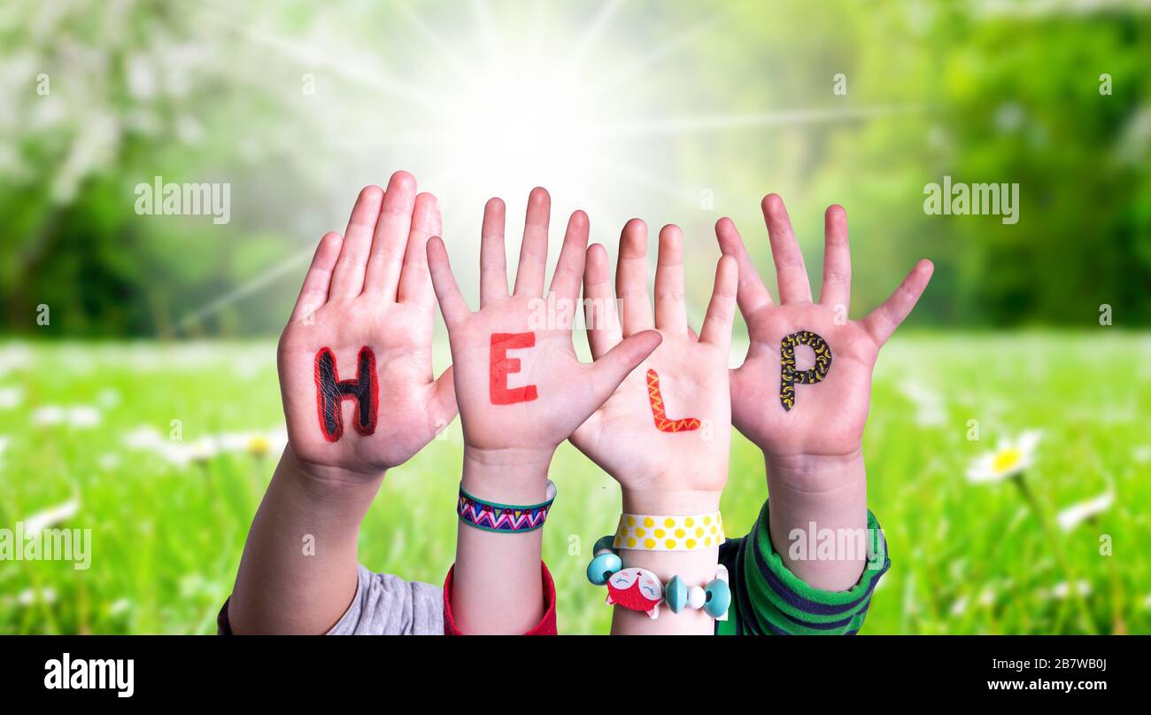 Children Hands Building Word Help, Grass Meadow Stock Photo - Alamy