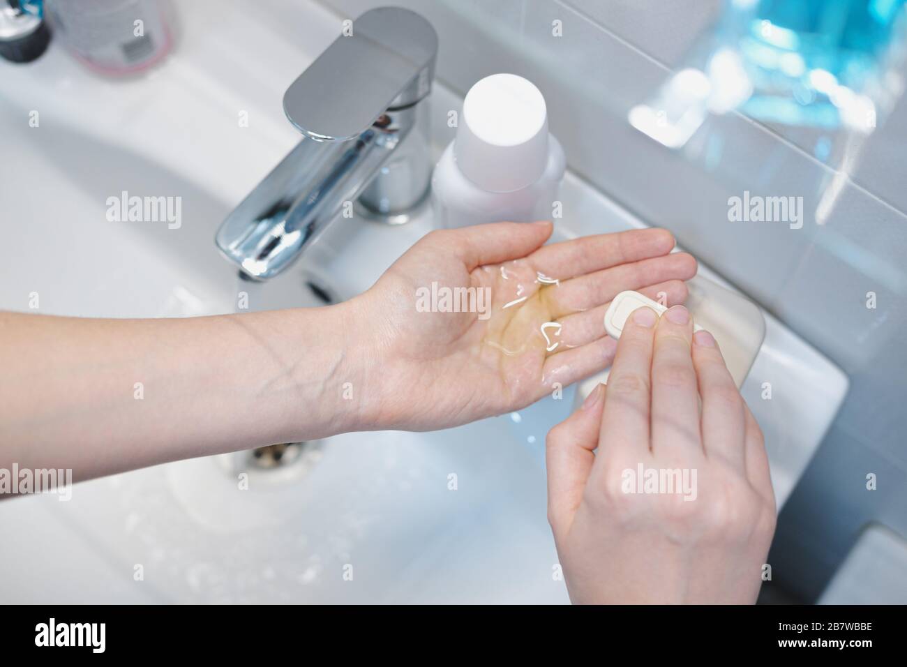 Cleaning hands with sanitizer and soap in bathroom. Concept of self ...