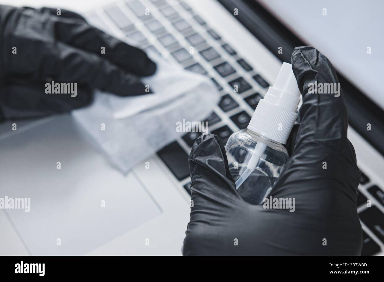 Cleaning laptop's keyboard with a sanitizer. Concept of hygiene and ...