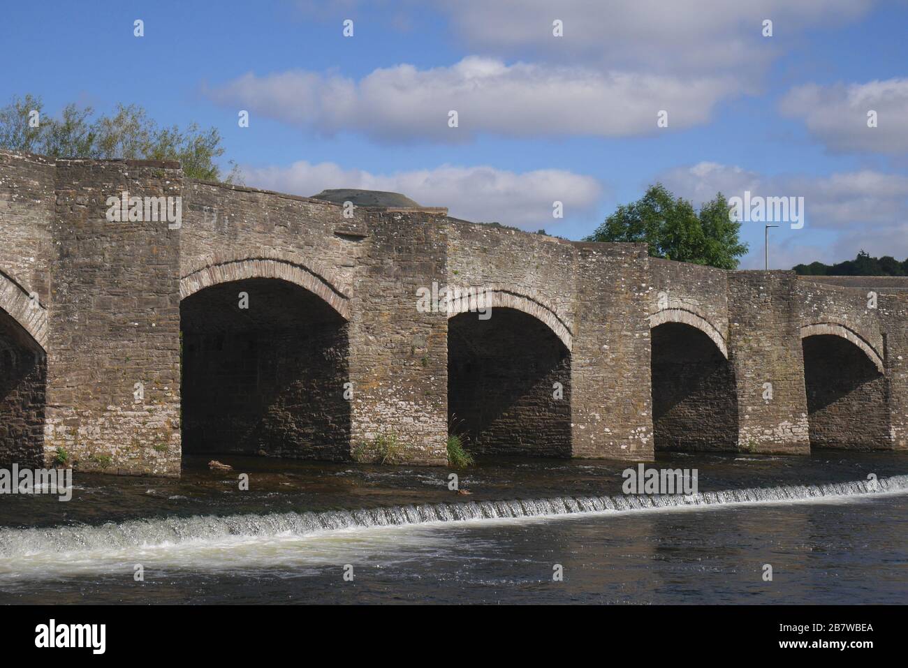 The Grade 1 listed 18th century bridge, standing above a weir, across ...