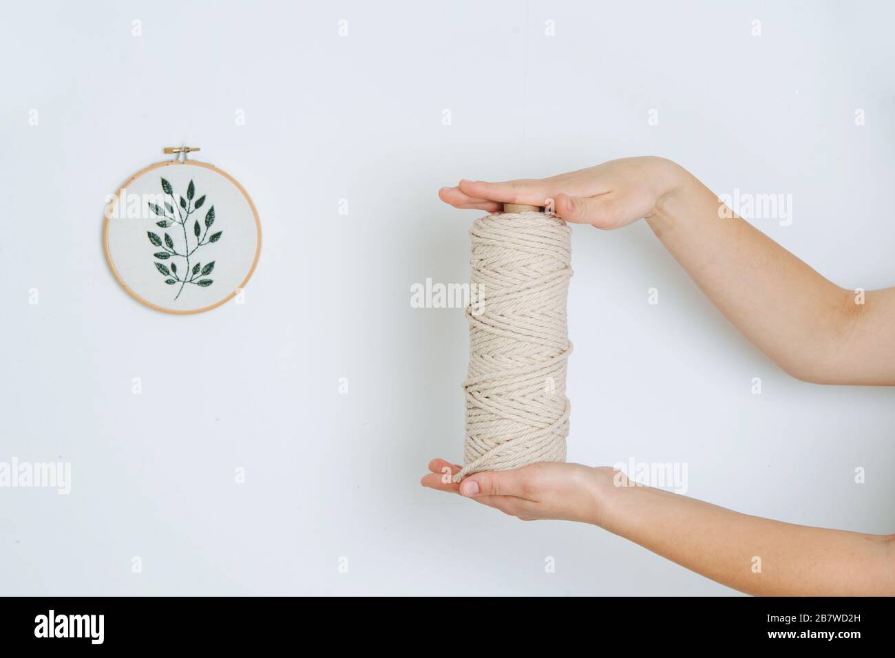 The girl's hands hold a cotton rope for the macrame Stock Photo - Alamy