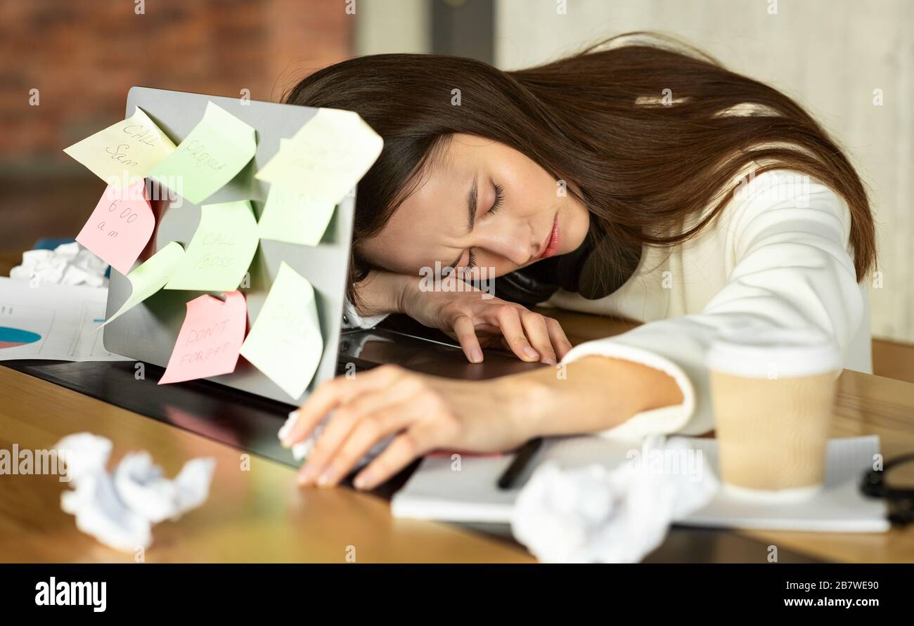 Young woman sleeping in front of laptop Stock Photo - Alamy