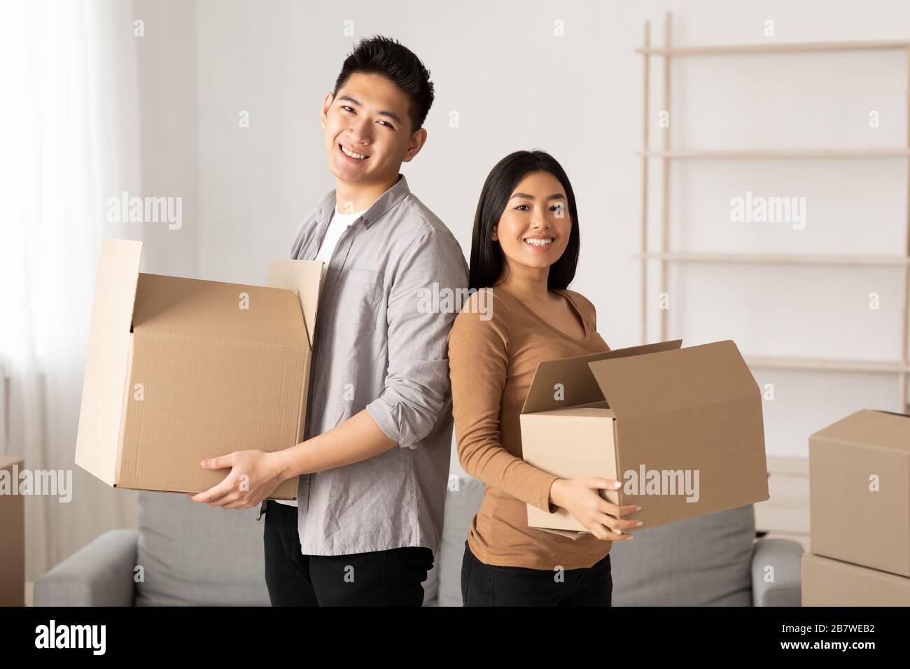 Asian man packing boxes hi-res stock photography and images - Alamy
