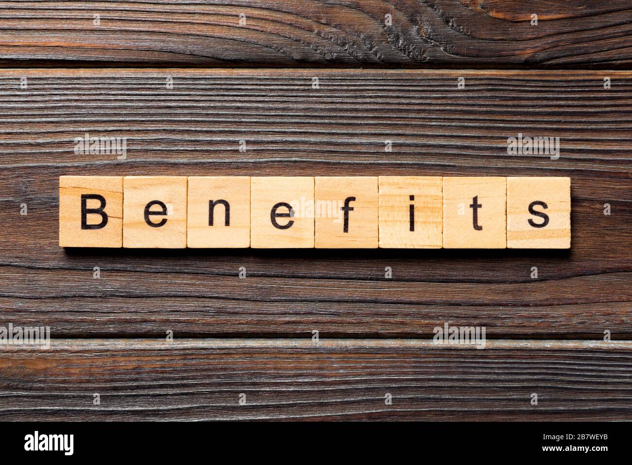 Benefits word written on wood block. Benefits text on wooden table for ...