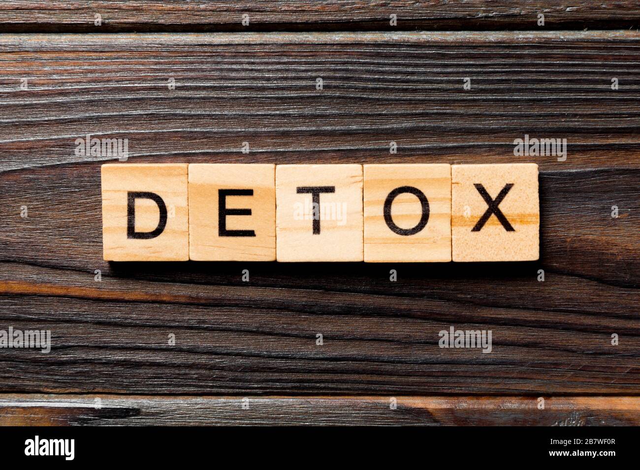 detox word written on wood block. detox text on wooden table for your ...