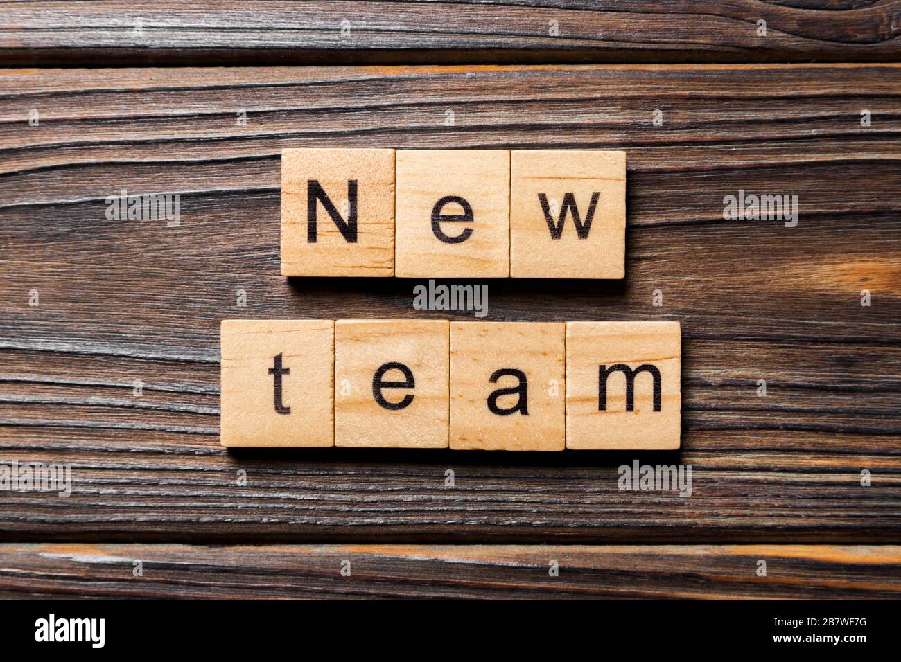 new team word written on wood block. new team text on table, concept ...