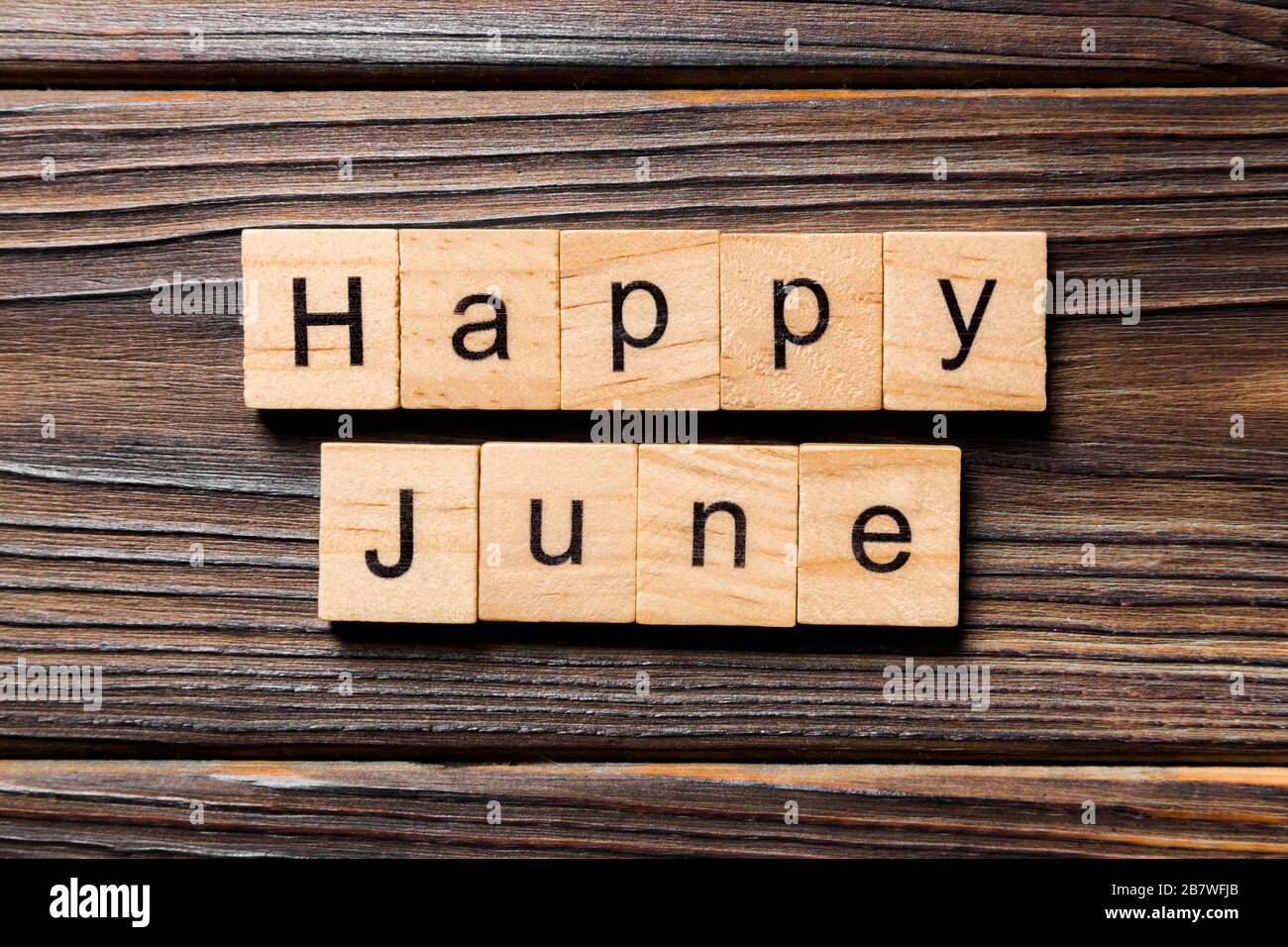 Happy June word written on wood block. Happy June text on table ...