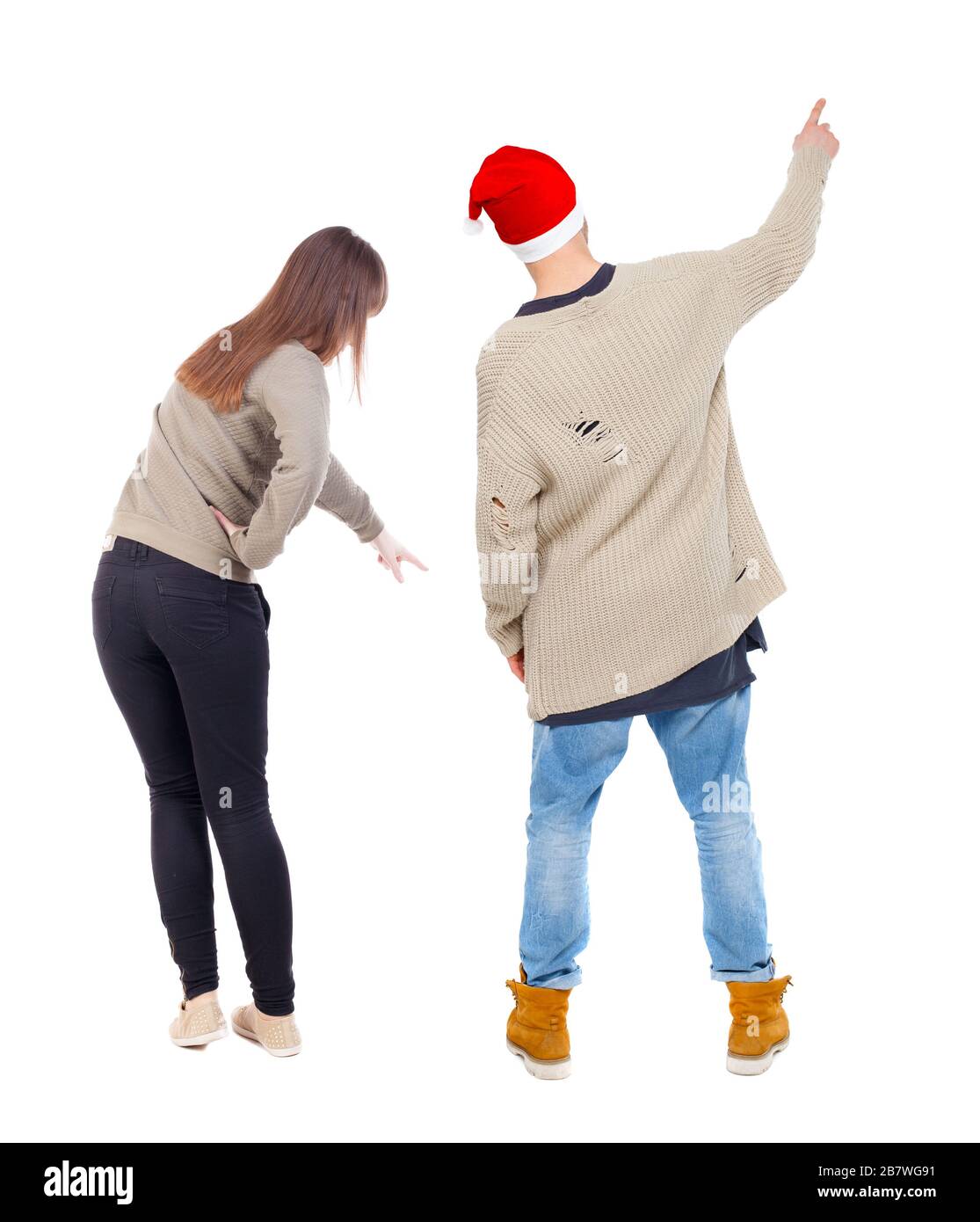 Back view of couple in sweater pointing. Rear view people collection ...