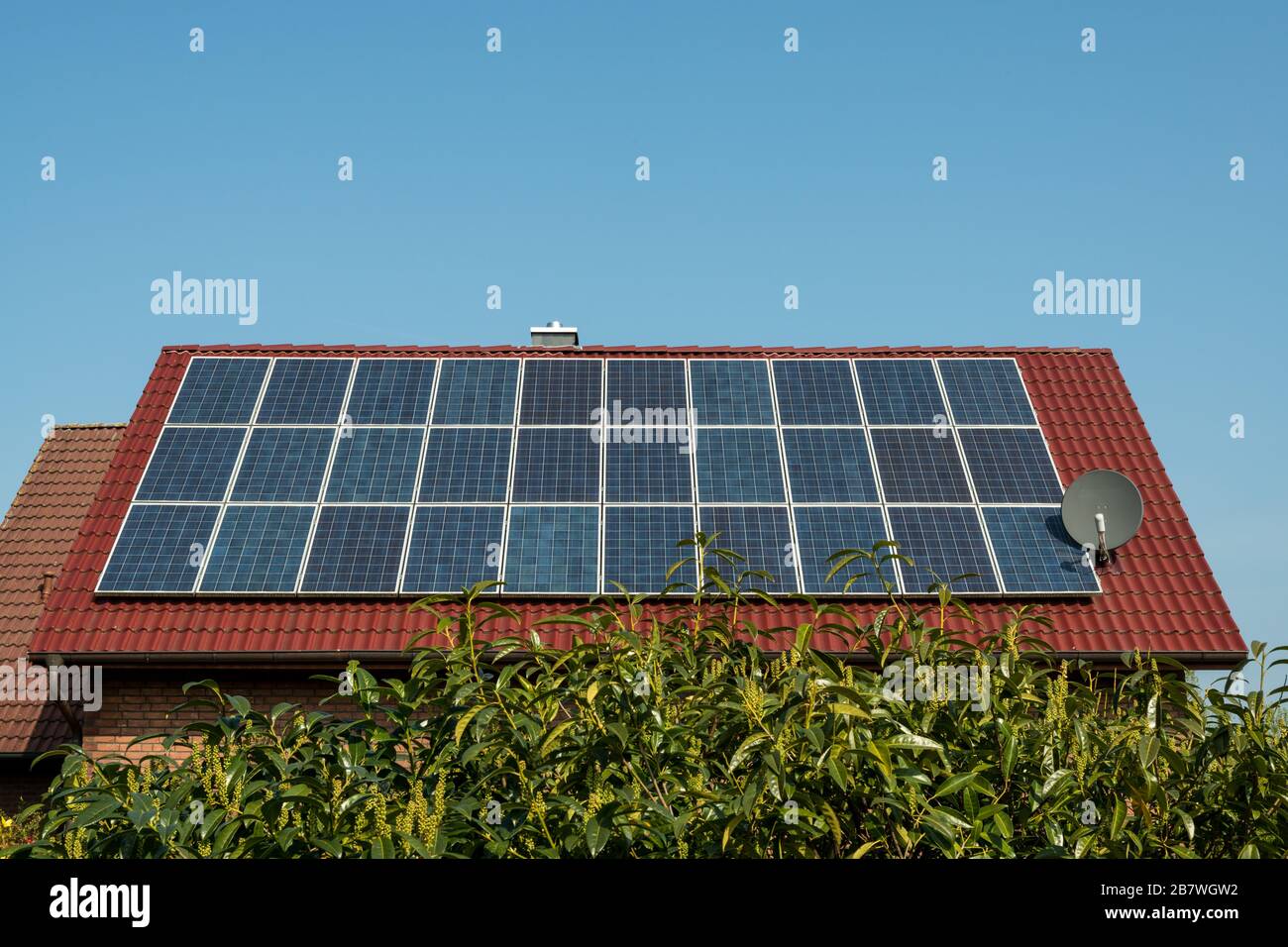 Solar panel on a red roof Stock Photo - Alamy