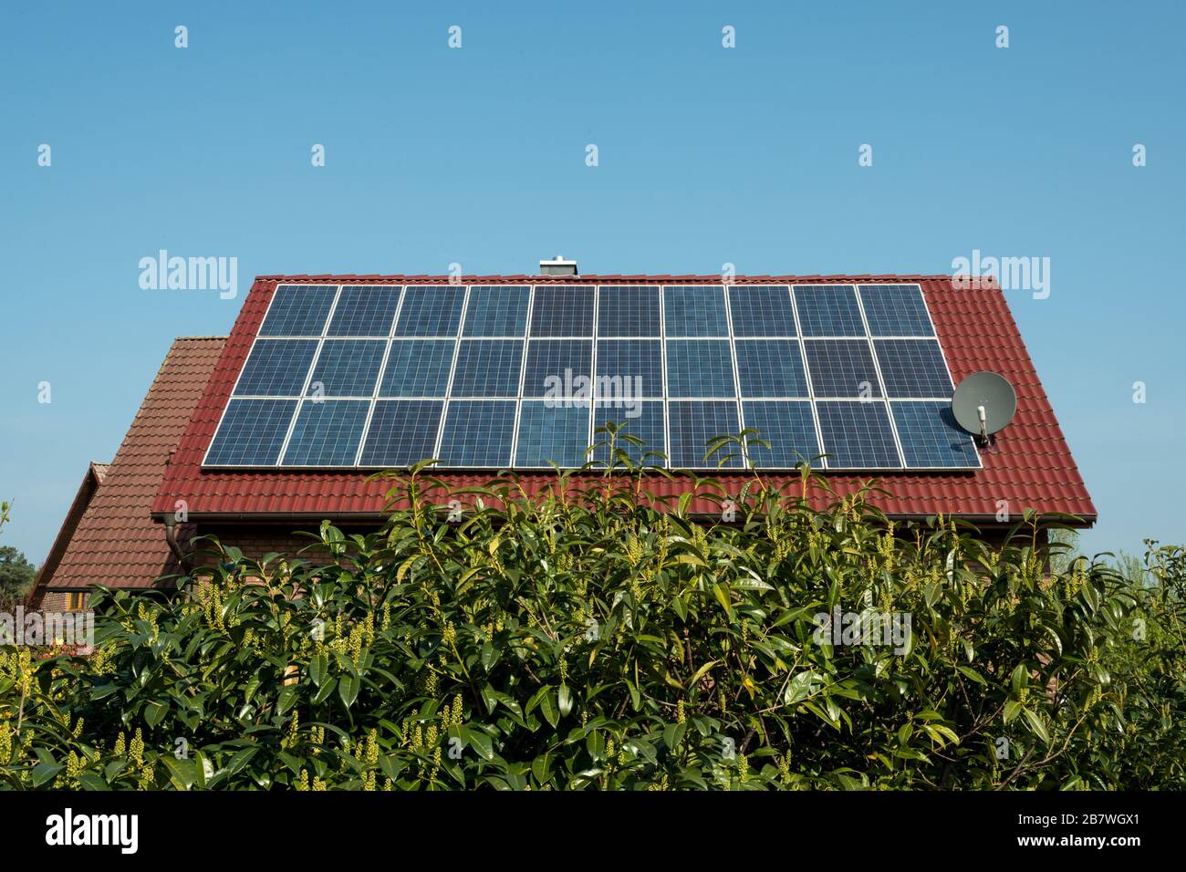 Solar panel on a red roof Stock Photo - Alamy