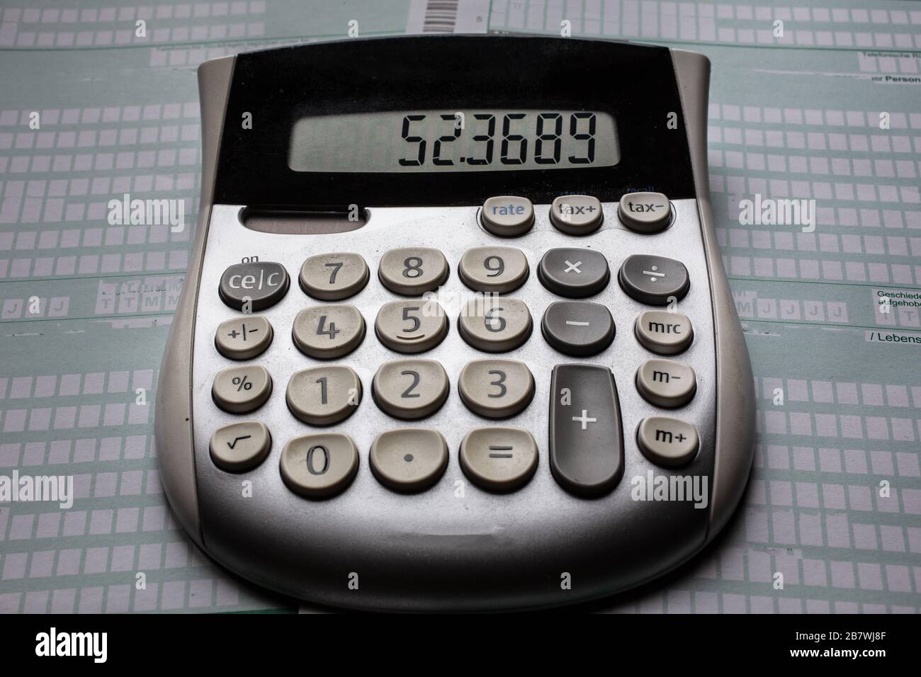 Calculator on forms for tax declaration Stock Photo - Alamy