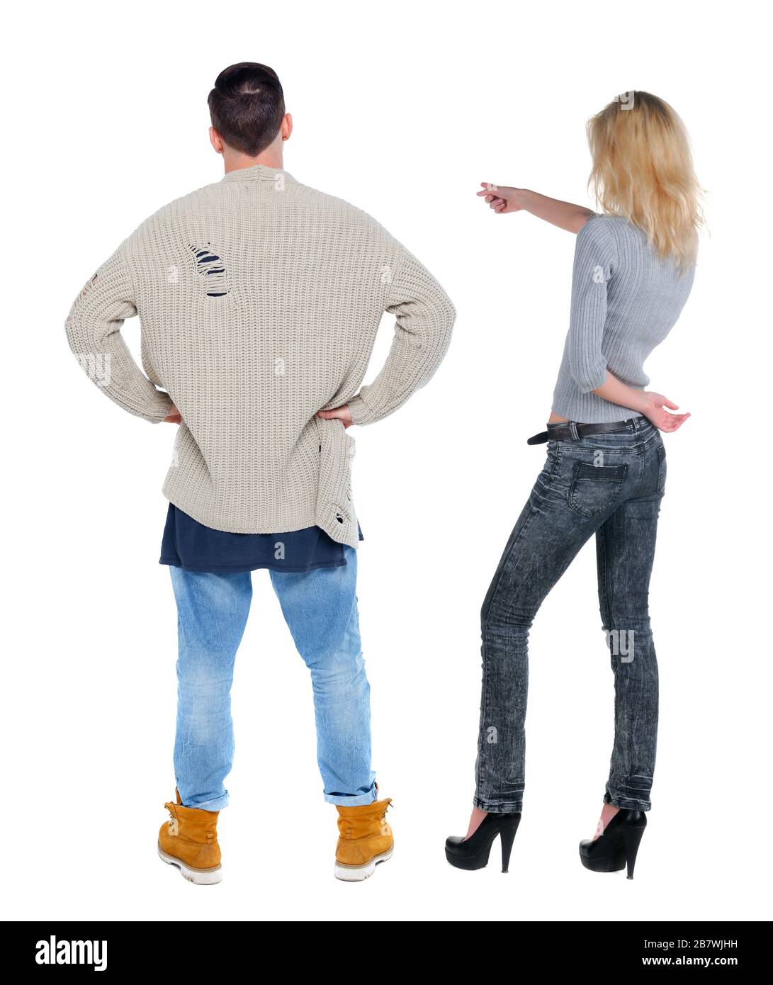 Back view of couple in sweater pointing. Rear view people collection ...