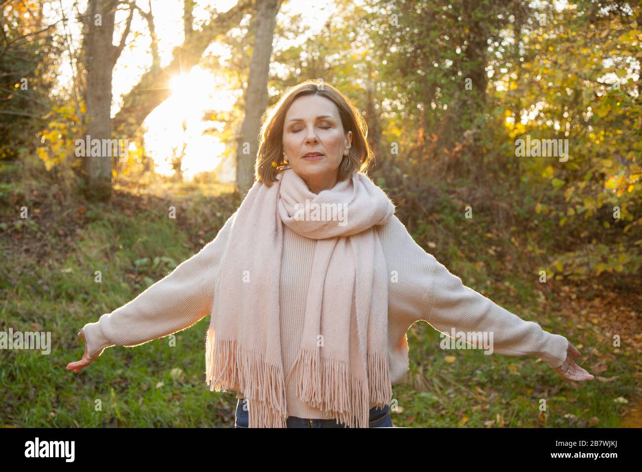 Woman arms raised jumper hi-res stock photography and images - Alamy