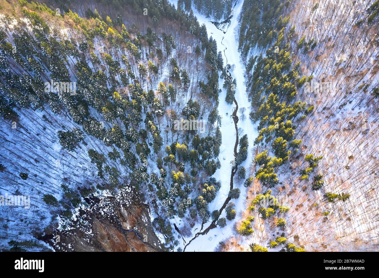 Amazing aerial view of forests and a road in winter time seen from ...