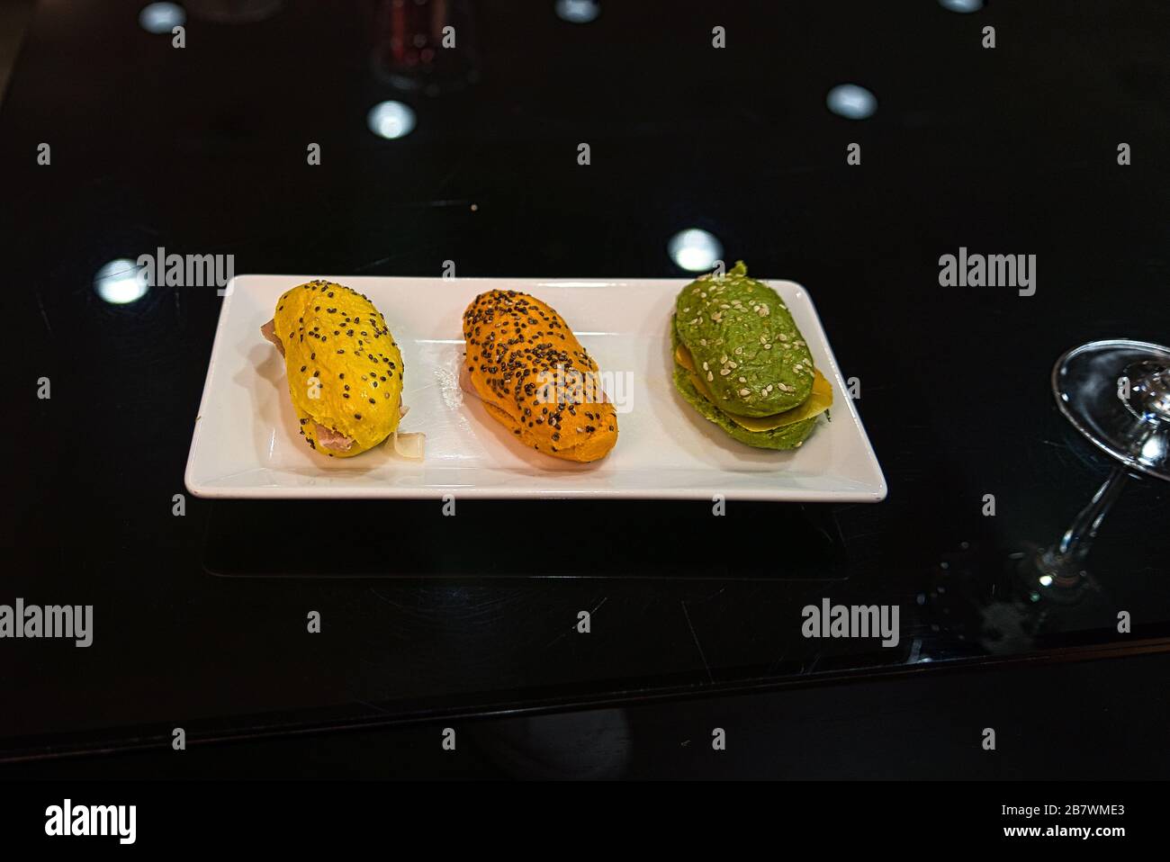 Food trend, finger food, sandwiches and a glass of champagne in a ...