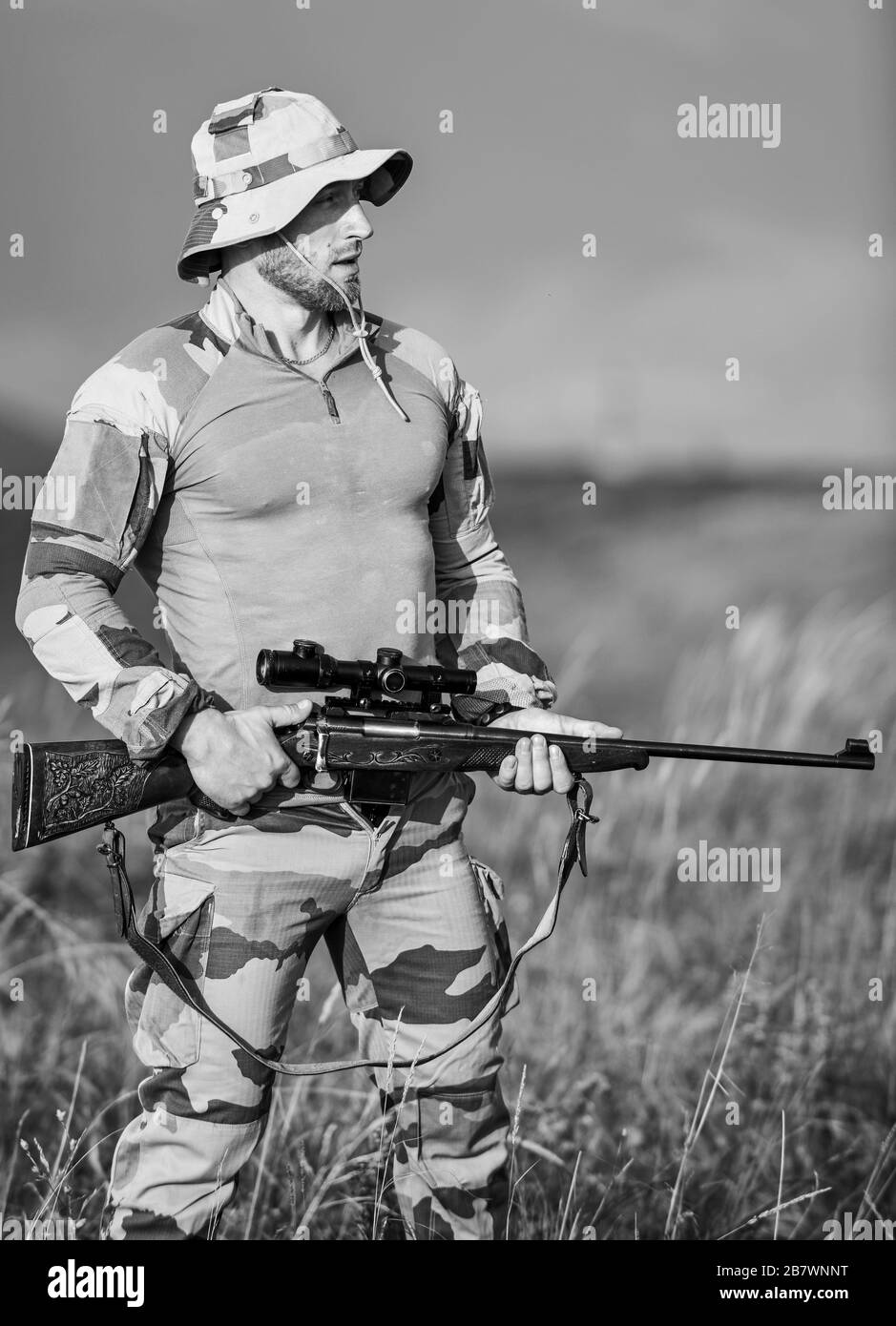 Ready to shoot. Focus and concentration experienced hunter. Hunter hold ...