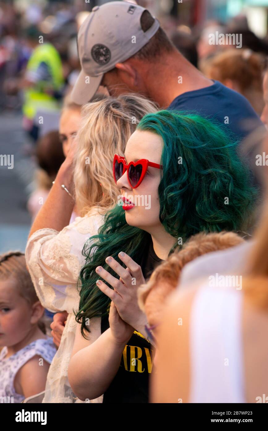 Flamboyant young female with green hair attending 4th of July ...