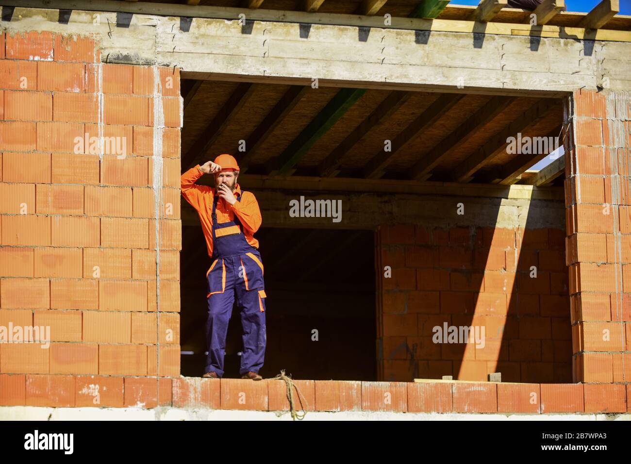 repairman engineer wear helmet on site. tired builder relax ...