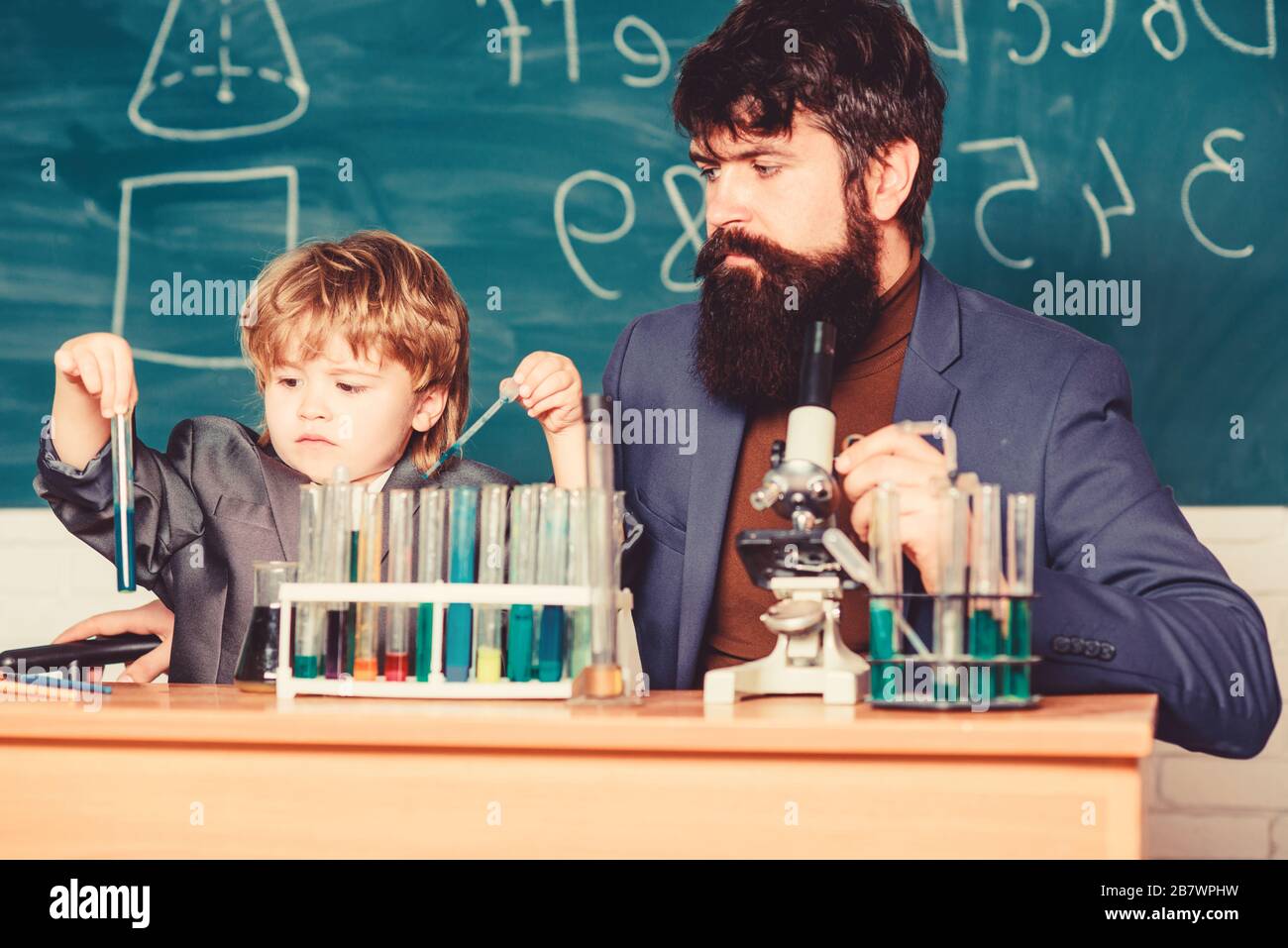 Modern Laboratory. son and father at school. Biologist Conducts ...