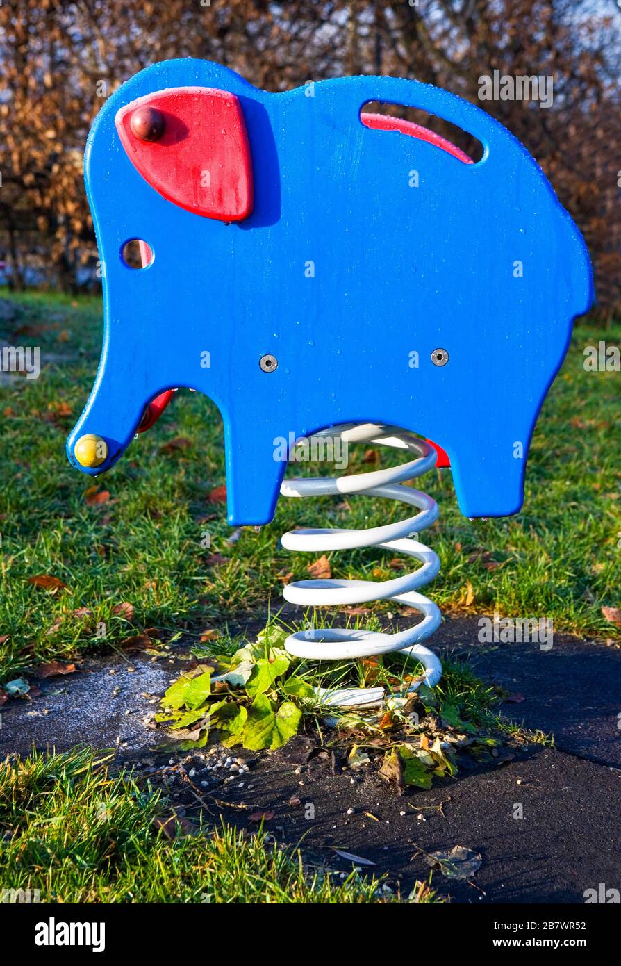 Rain wet seesaw on a playground, elephant seesaw, playground equipment ...