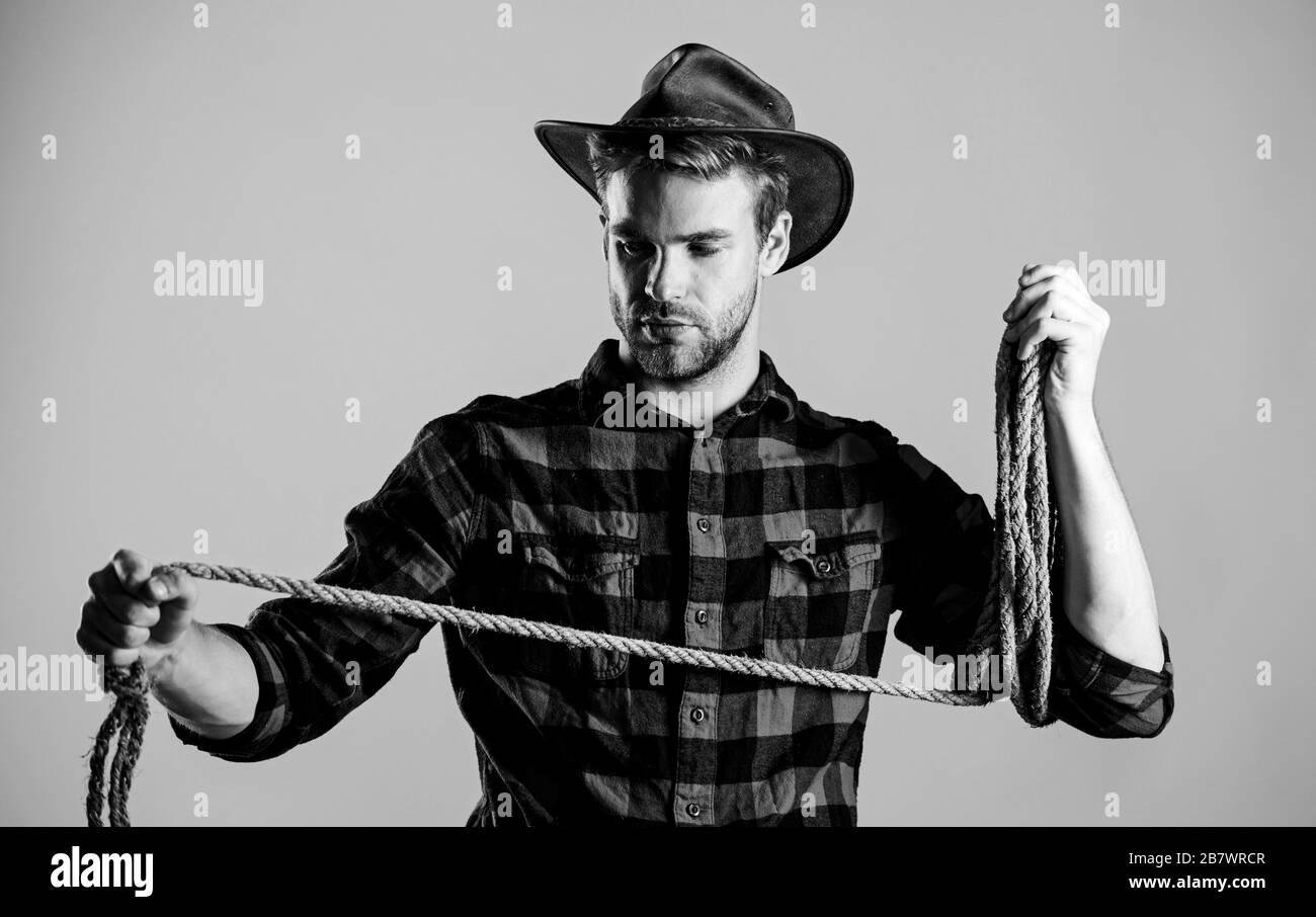 lasso master. man checkered shirt on ranch. western cowboy portrait ...