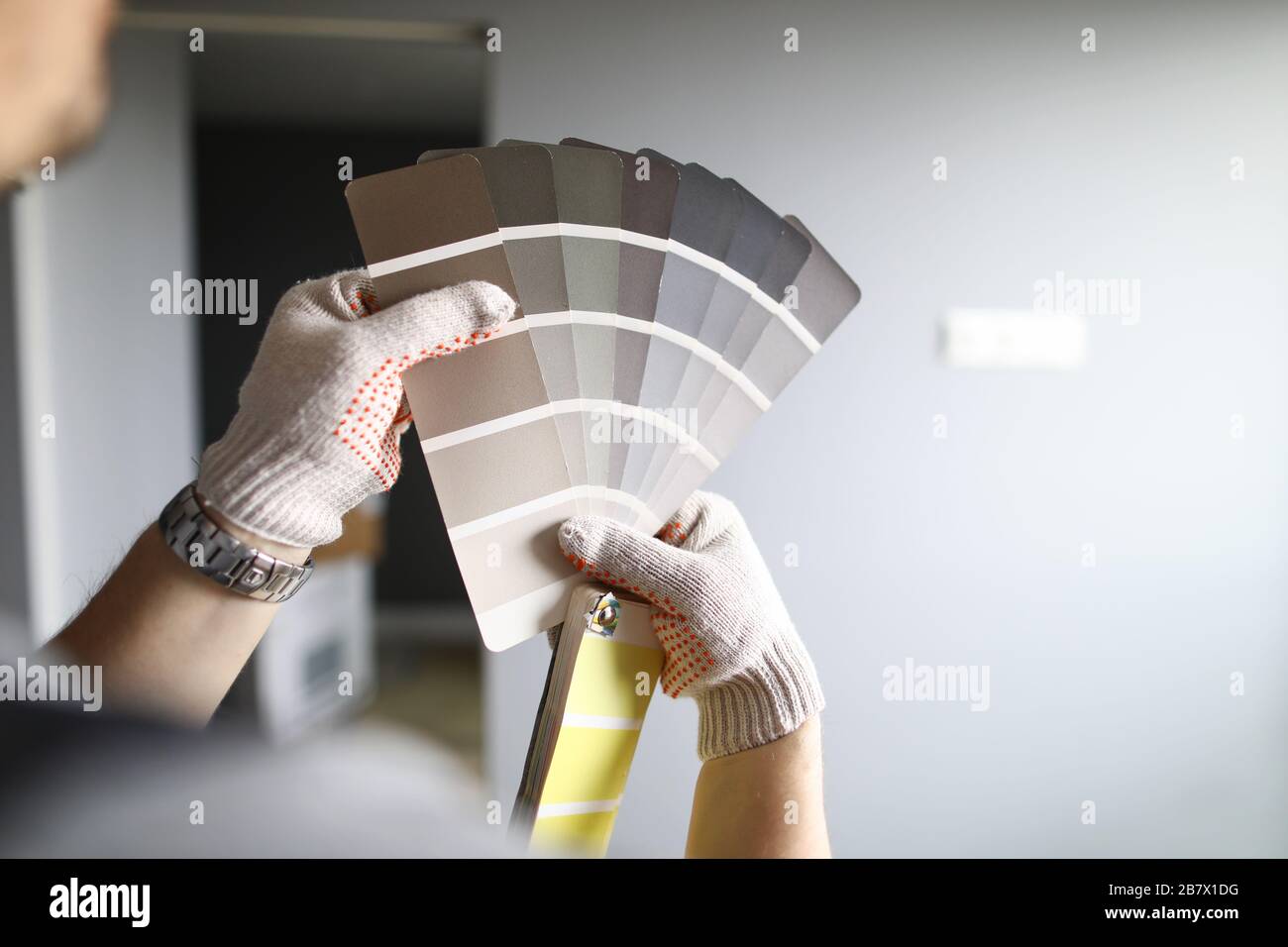 Repairmans hands with color palette over grey renovated walls Stock ...
