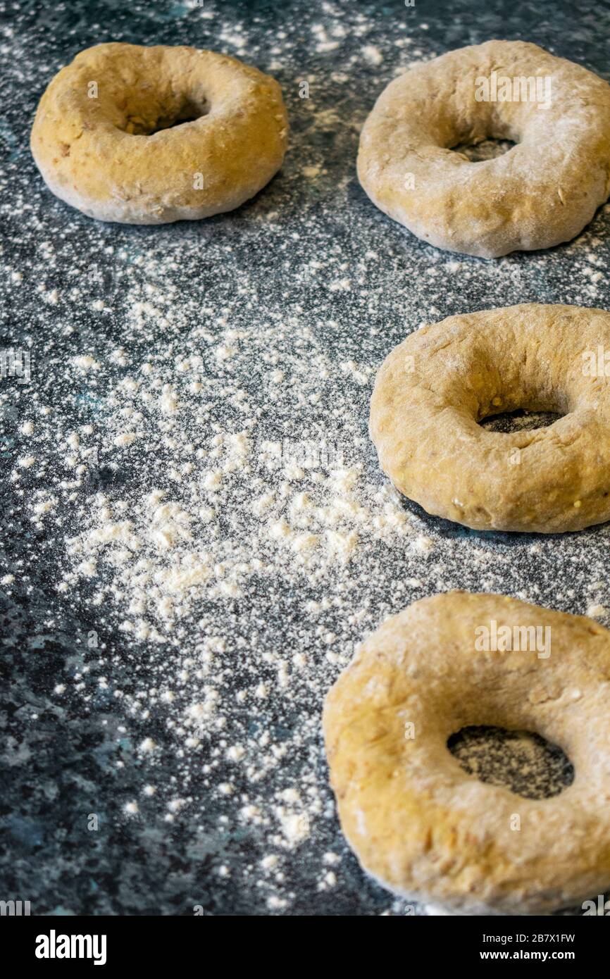 Raw bagels on a floured worktop ready to bake Stock Photo - Alamy