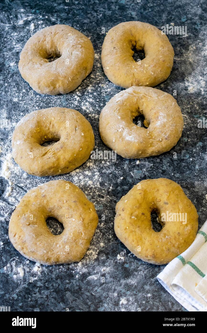 Raw bagels on a floured worktop ready to bake Stock Photo - Alamy