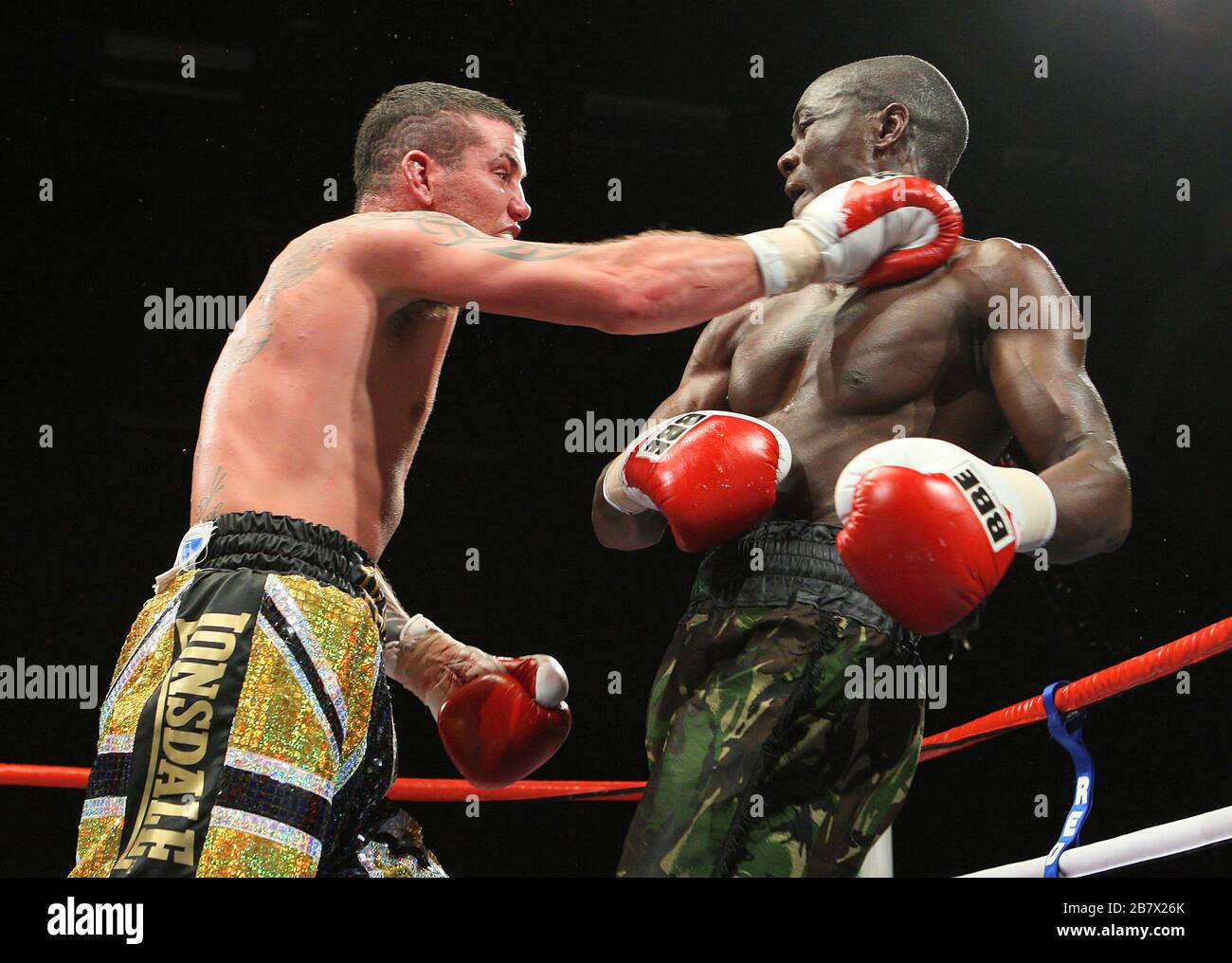 Travis Dickinson (yellow/black shorts) defeats Hastings Rasani in a ...