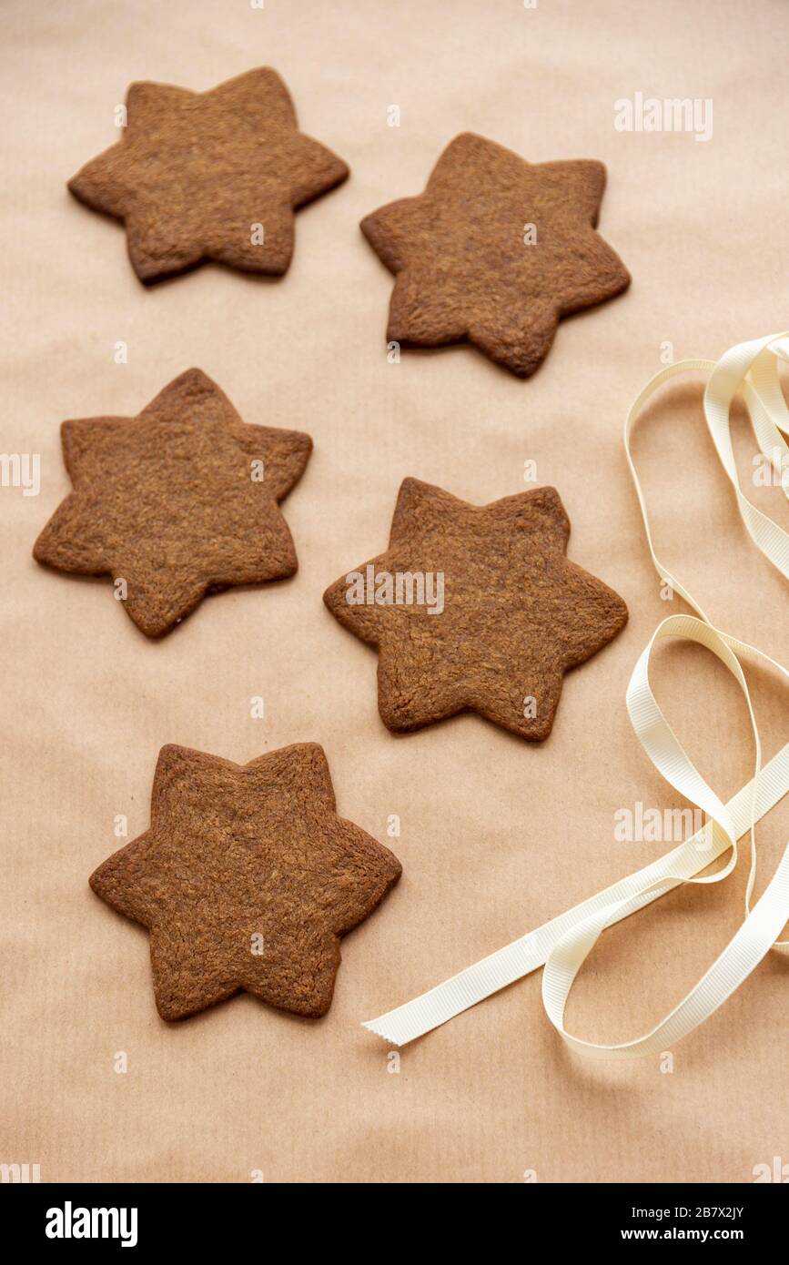 Homemade gingerbread star shaped ready to be made into decorations ...