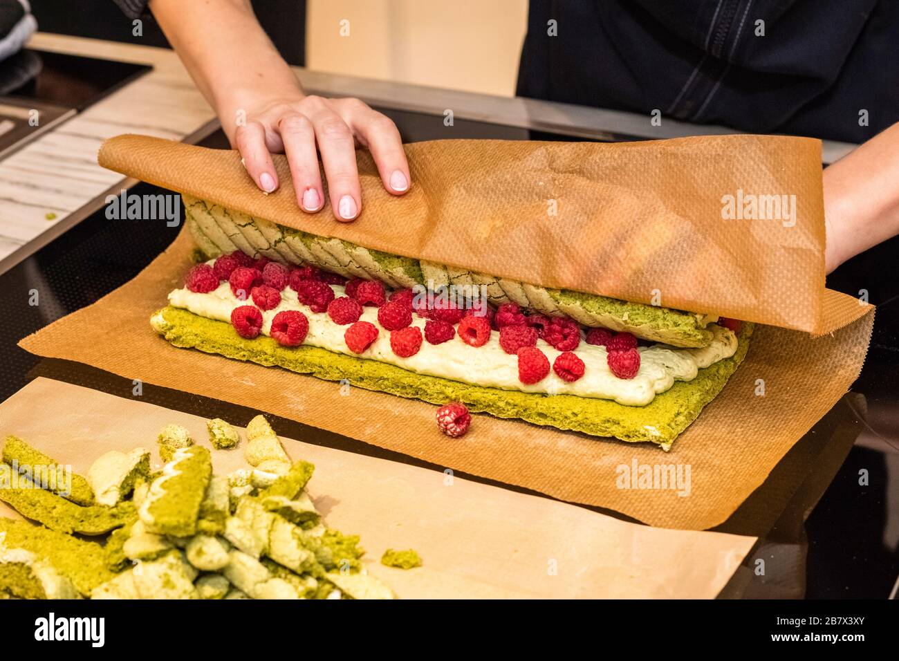 Cooking dessert with pistachio cream and fresh raspberries. Pistachio ...