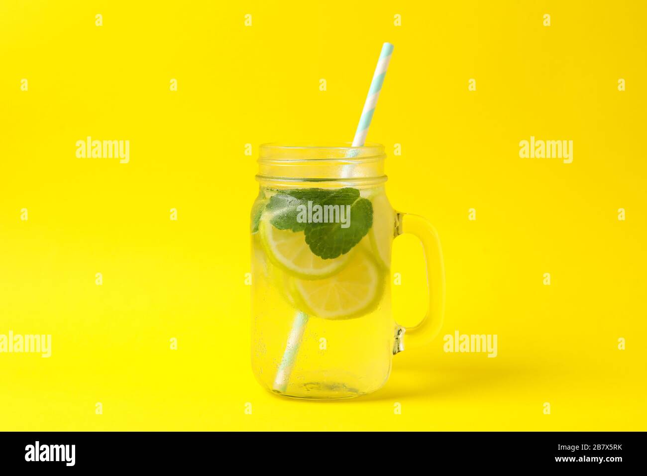 Glass jar with lemonade on yellow background. Fresh drink Stock Photo ...