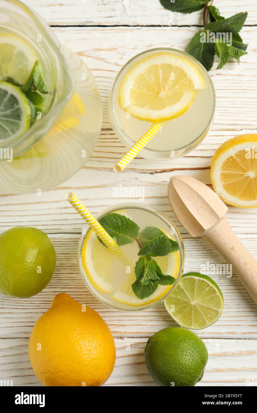 Fresh lemonade in different glasses on wooden background, top view ...