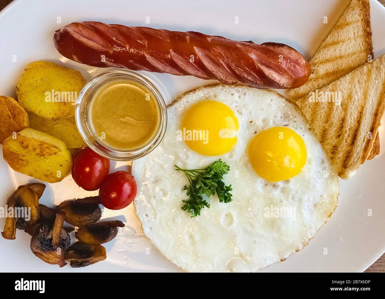 Traditional full breakfast with fried eggs, sausage, mushrooms, grilled ...