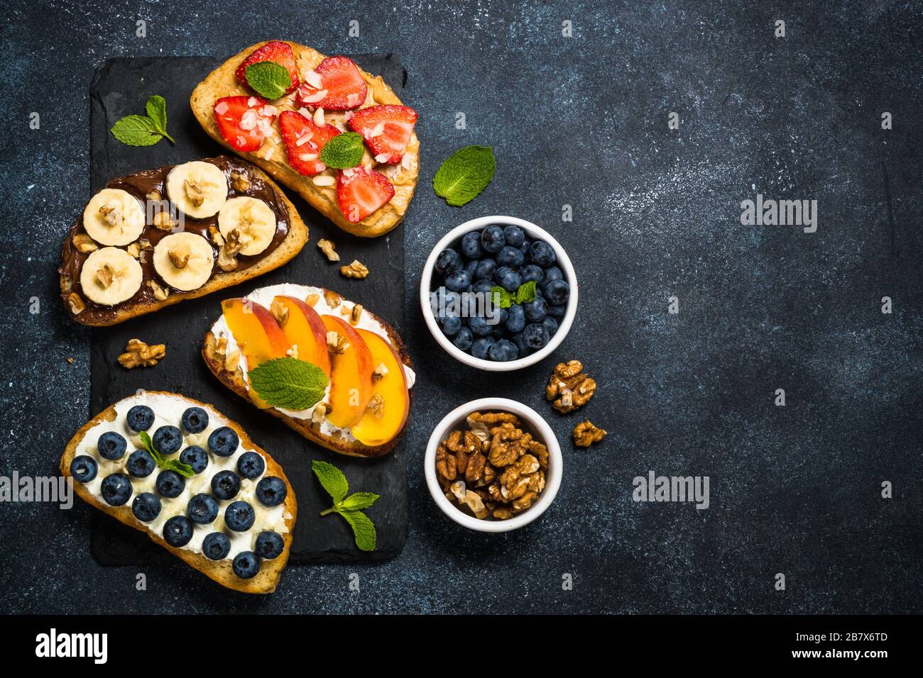 Sweet toast assortment with fresh fruit and berries on white Stock ...