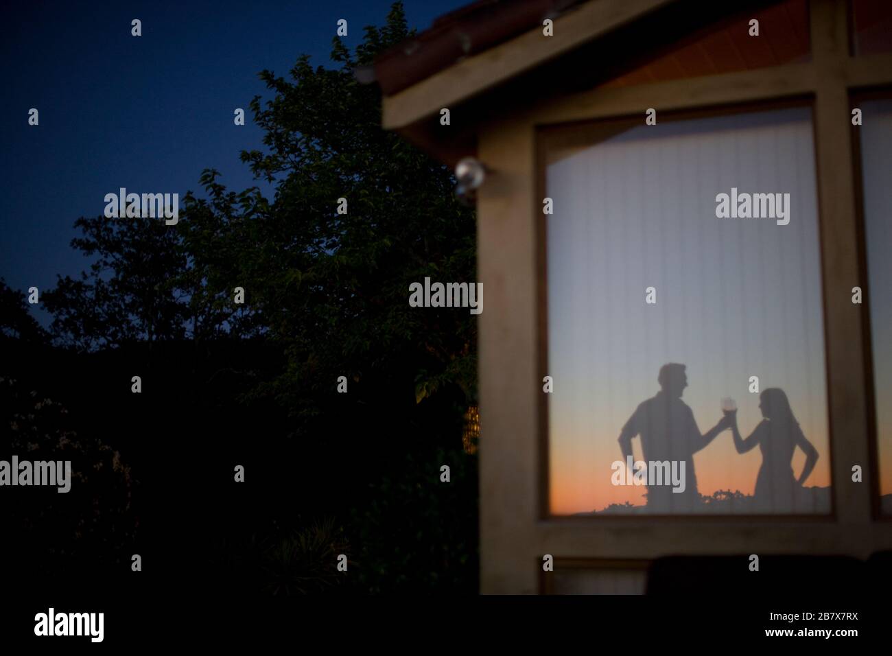 Reflection of people in a window at twilight Stock Photo - Alamy