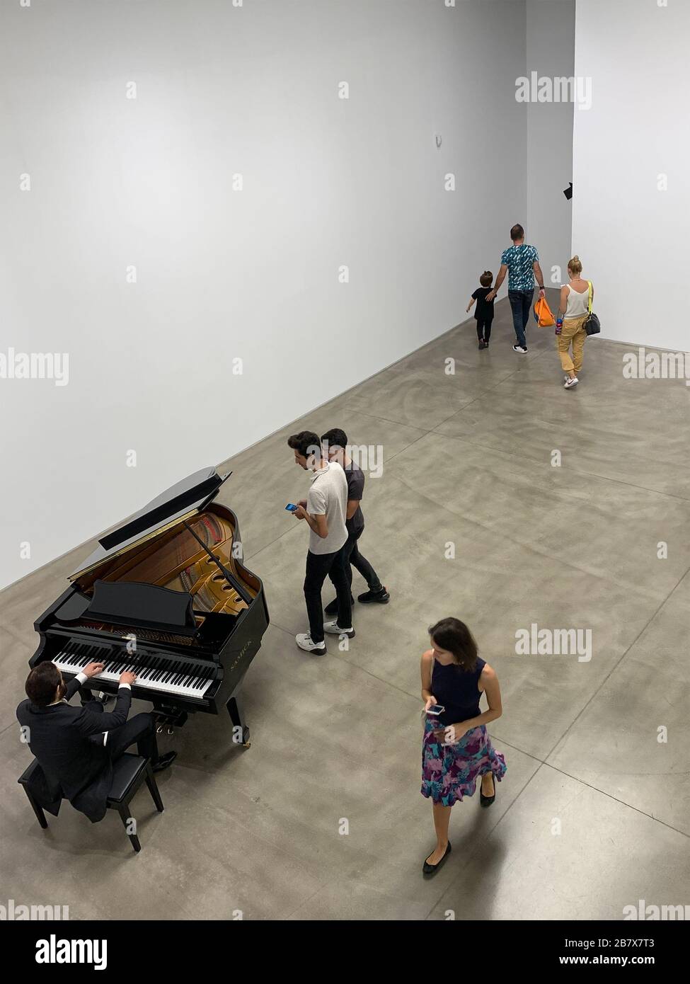 View of people visiting an exhibition at an art gallery in Beyoglu area ...
