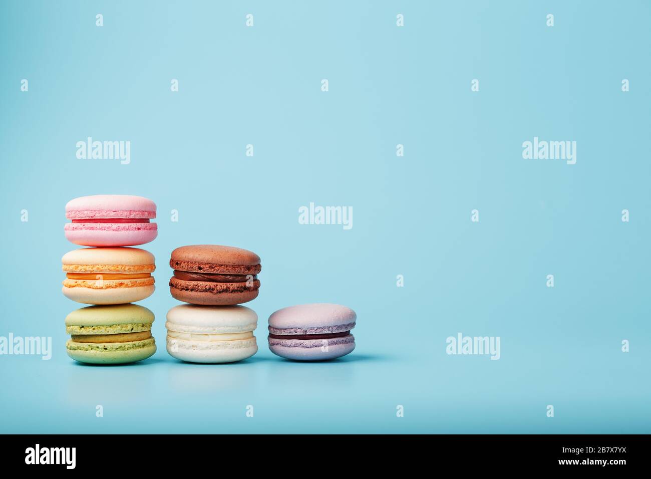 Macaroni cookies of different colors are arranged in the shape of ...