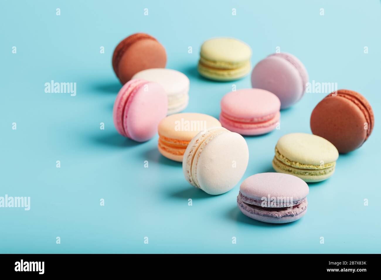 Multicolored French macaroni macaroni cookies on a blue background ...