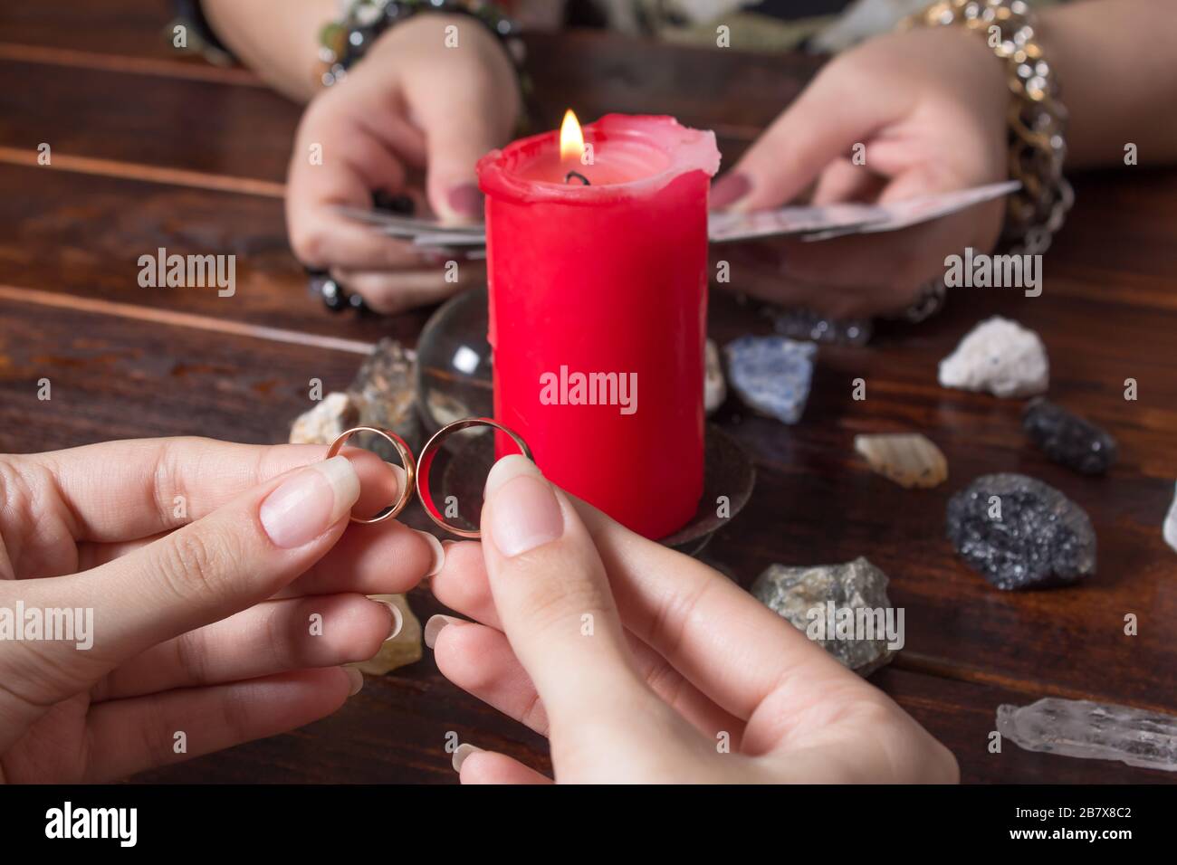 A Gypsy woman guesses a love match using wedding rings and fortune ...