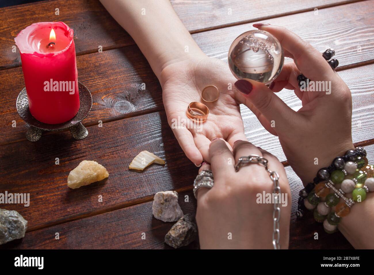 A fortune teller predicts the fate of love with wedding rings, a magic ...